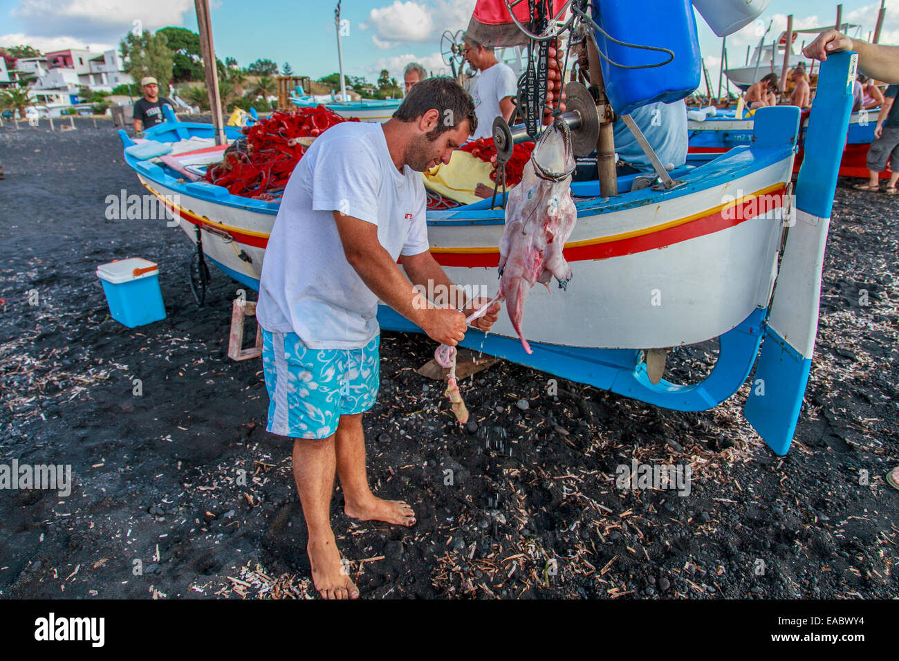 A fisherman cleaning fish Stock Photo - Alamy