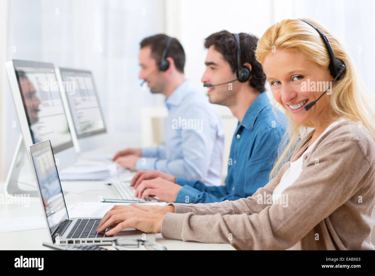 View of a Young attractive woman working in a call center Stock Photo ...