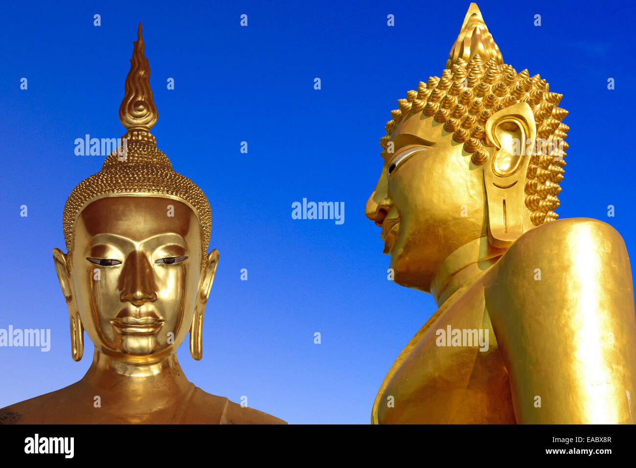 Two golden Buddhas in Thailand Stock Photo - Alamy
