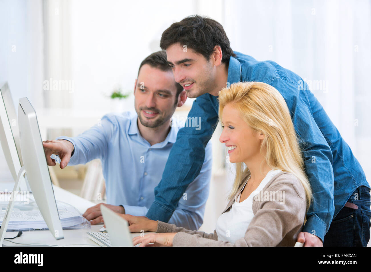 View of a Group of young active people working together Stock Photo - Alamy