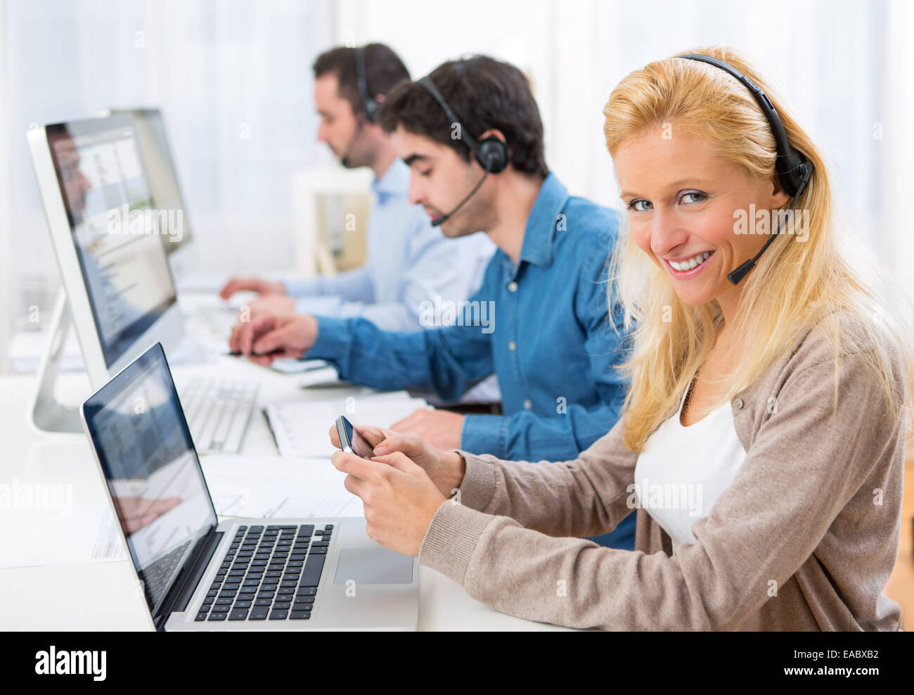 View of a Young attractive woman sending text at work Stock Photo - Alamy