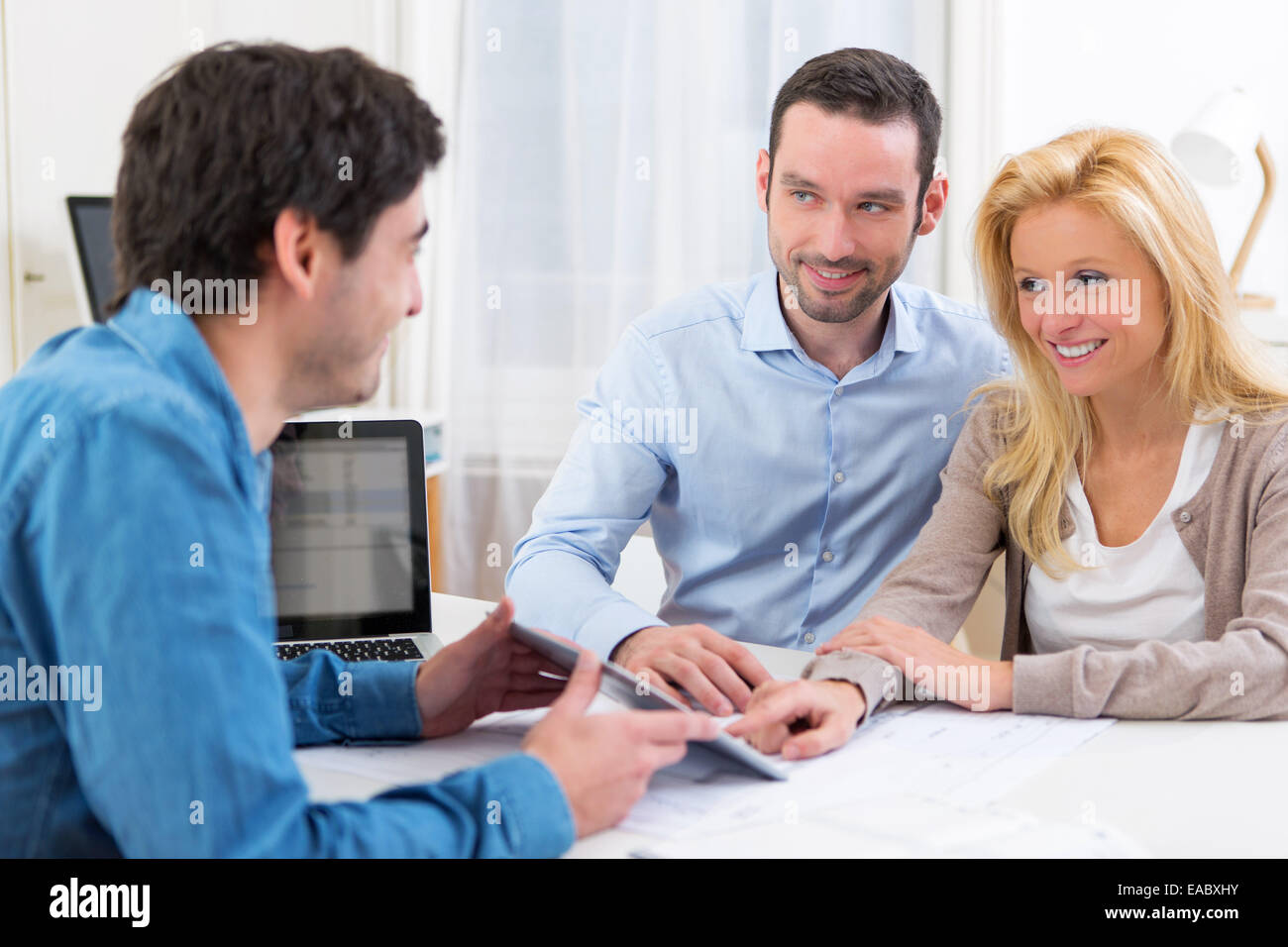 View of a Young attractive couple signing contract on tablet Stock ...