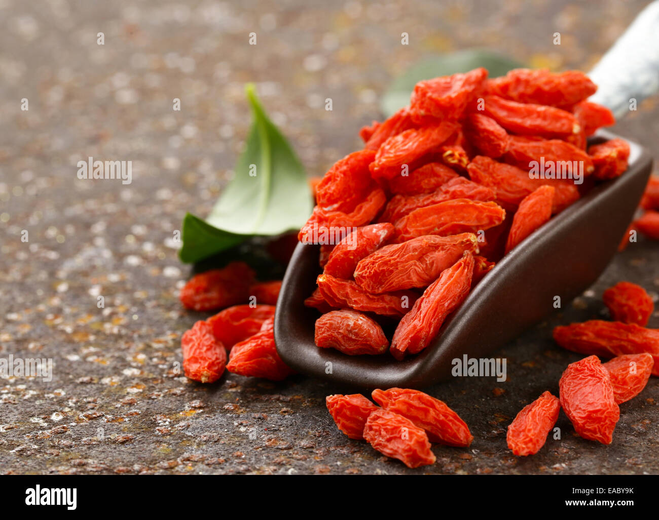 useful red goji berries on a old iron background Stock Photo - Alamy