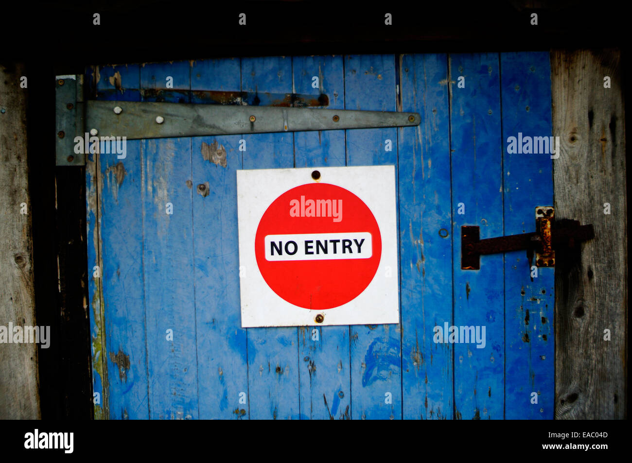 Red 'No Entry' sign on a rustic old blue wooden door Stock Photo - Alamy