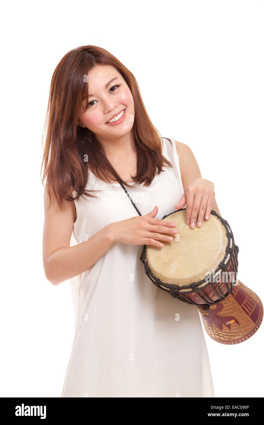 Chinese woman playing an African djembe Stock Photo - Alamy