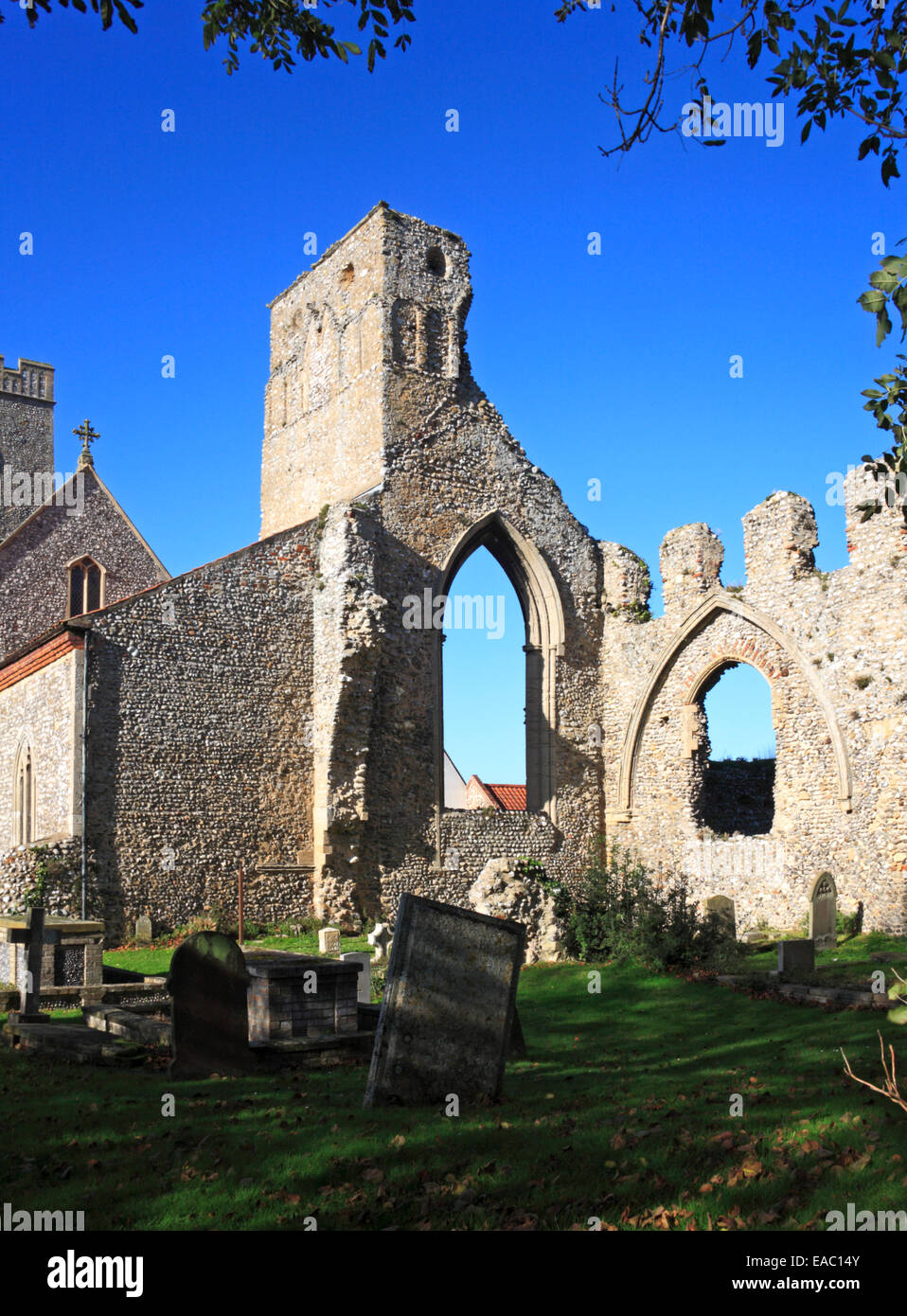A view of the 13th century priory remains with the Saxon tower at ...