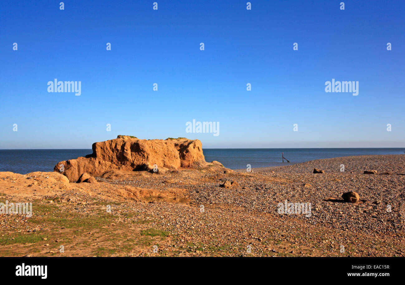 A view of the shingle beach with eroded cliffs at Weybourne on the ...