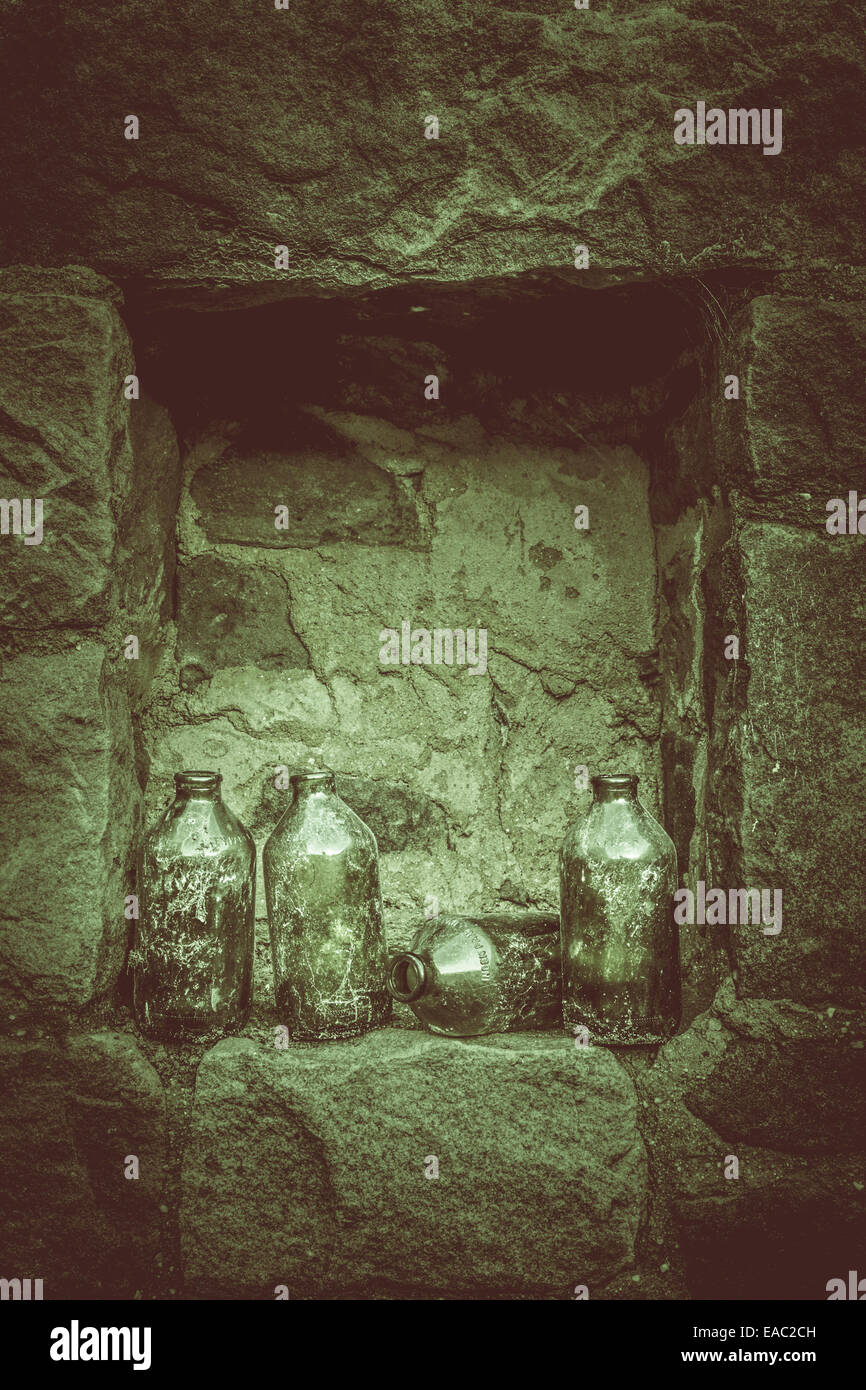 Old beer bottles on a stone wall Stock Photo - Alamy