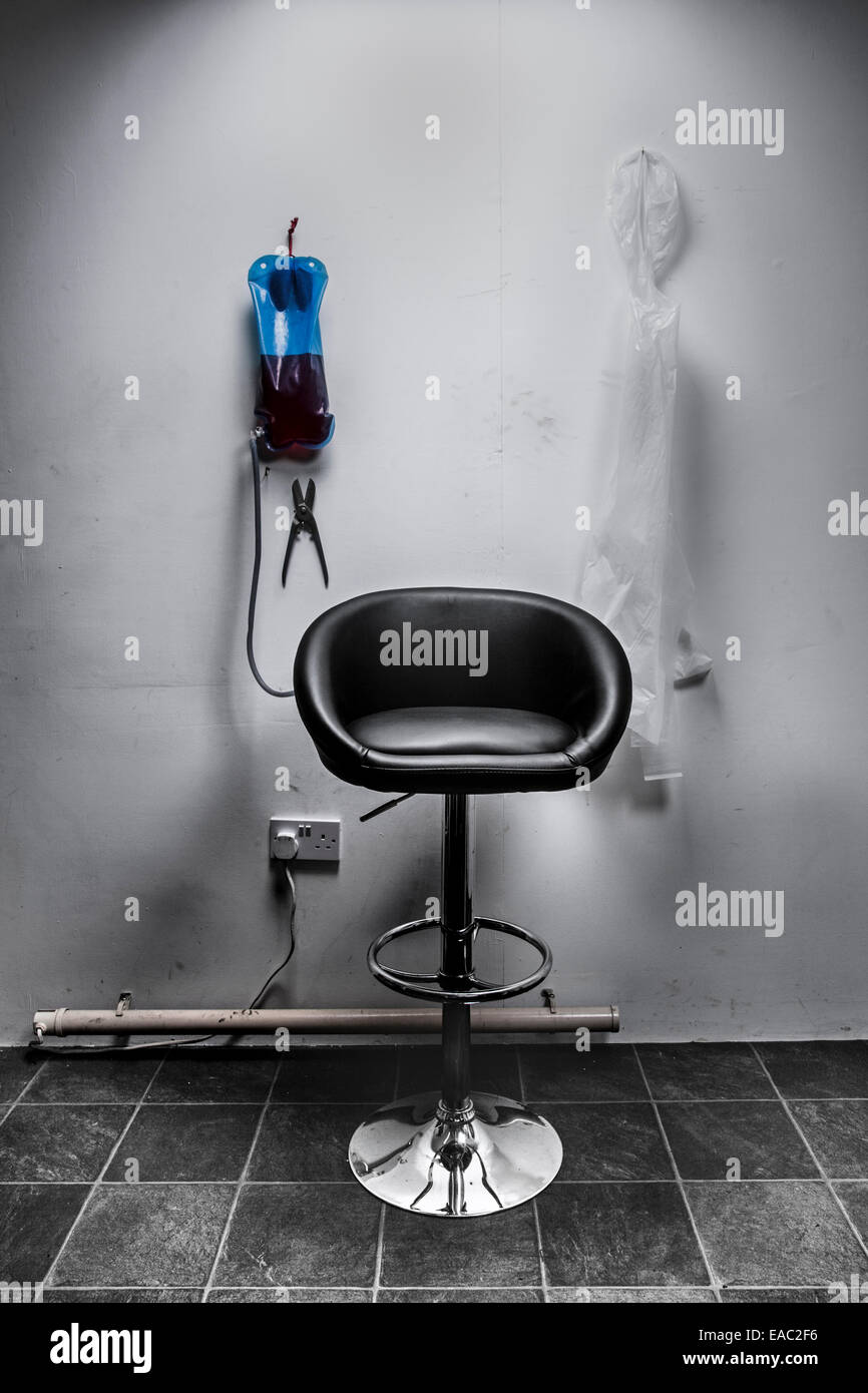 A chair in an unsettling room with blood bag and plastic apron Stock ...