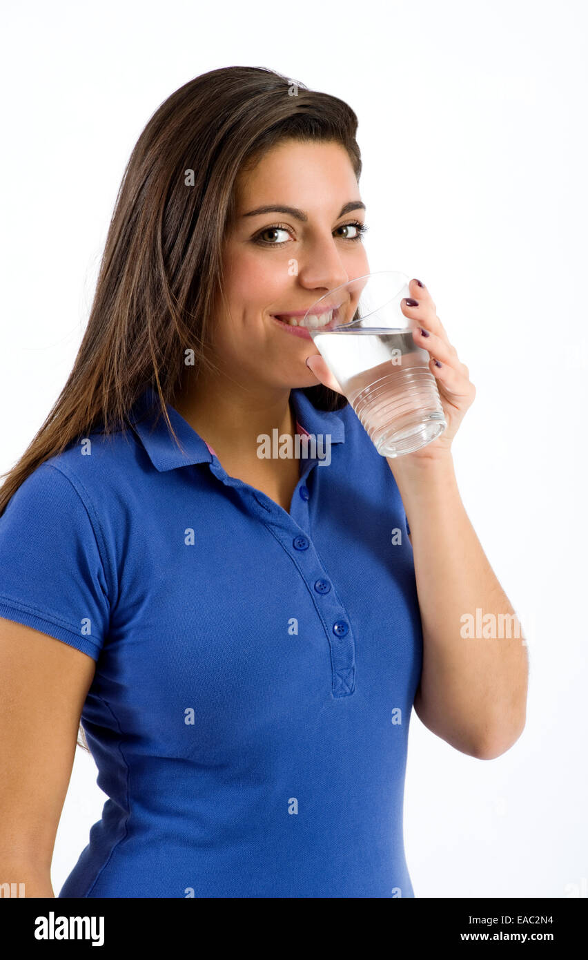 Young woman standing drinking a glass of fresh water Stock Photo - Alamy