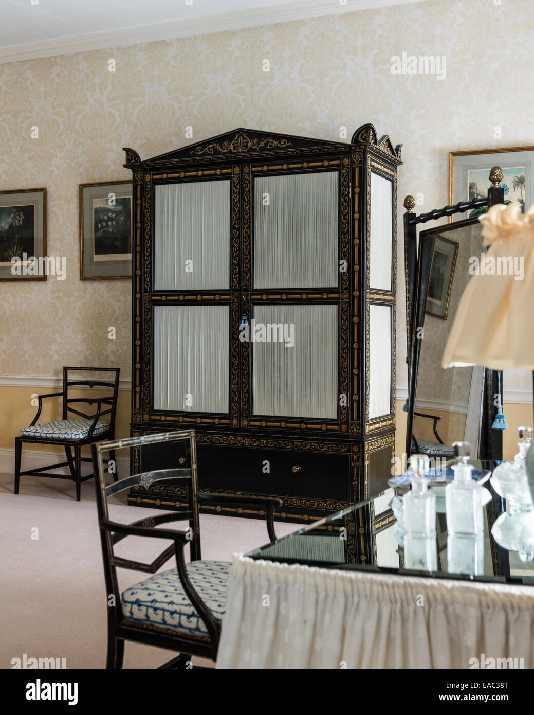 Gold and black lacquered wardrobe in bedroom Stock Photo - Alamy