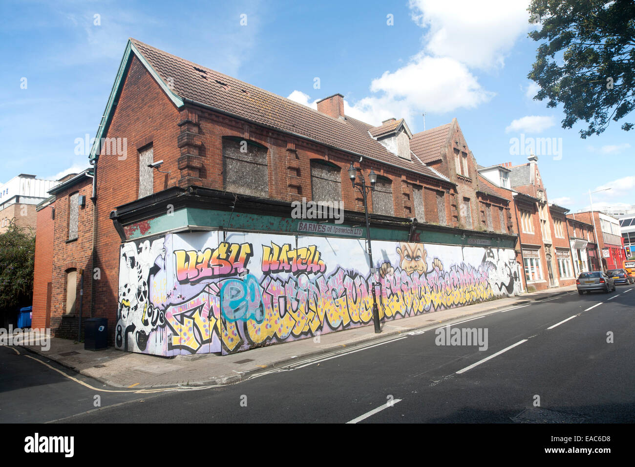 Painted hoarding boards around derelict shop buildings in Upper Orwell ...