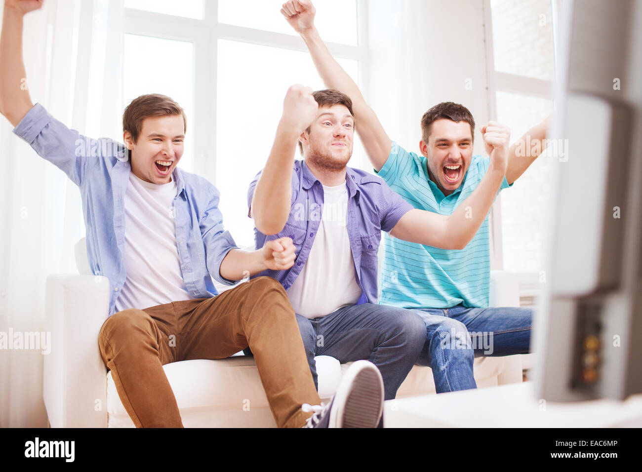happy male friends at home Stock Photo - Alamy