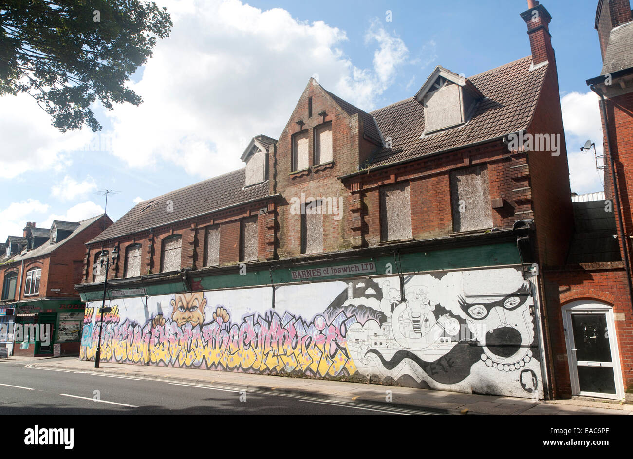 Painted hoarding boards around derelict shop buildings in Upper Orwell ...