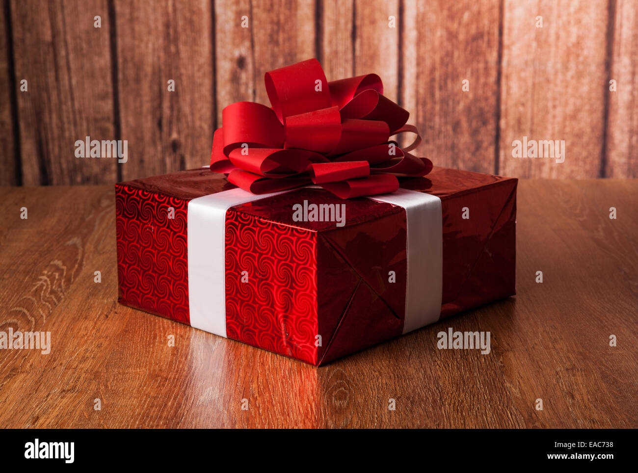 one large red gift box on a wood background Stock Photo - Alamy