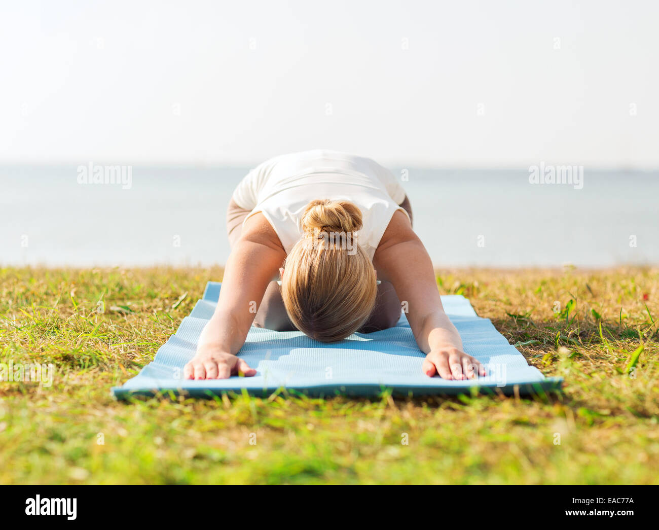 close up of woman making yoga exercises outdoors Stock Photo - Alamy