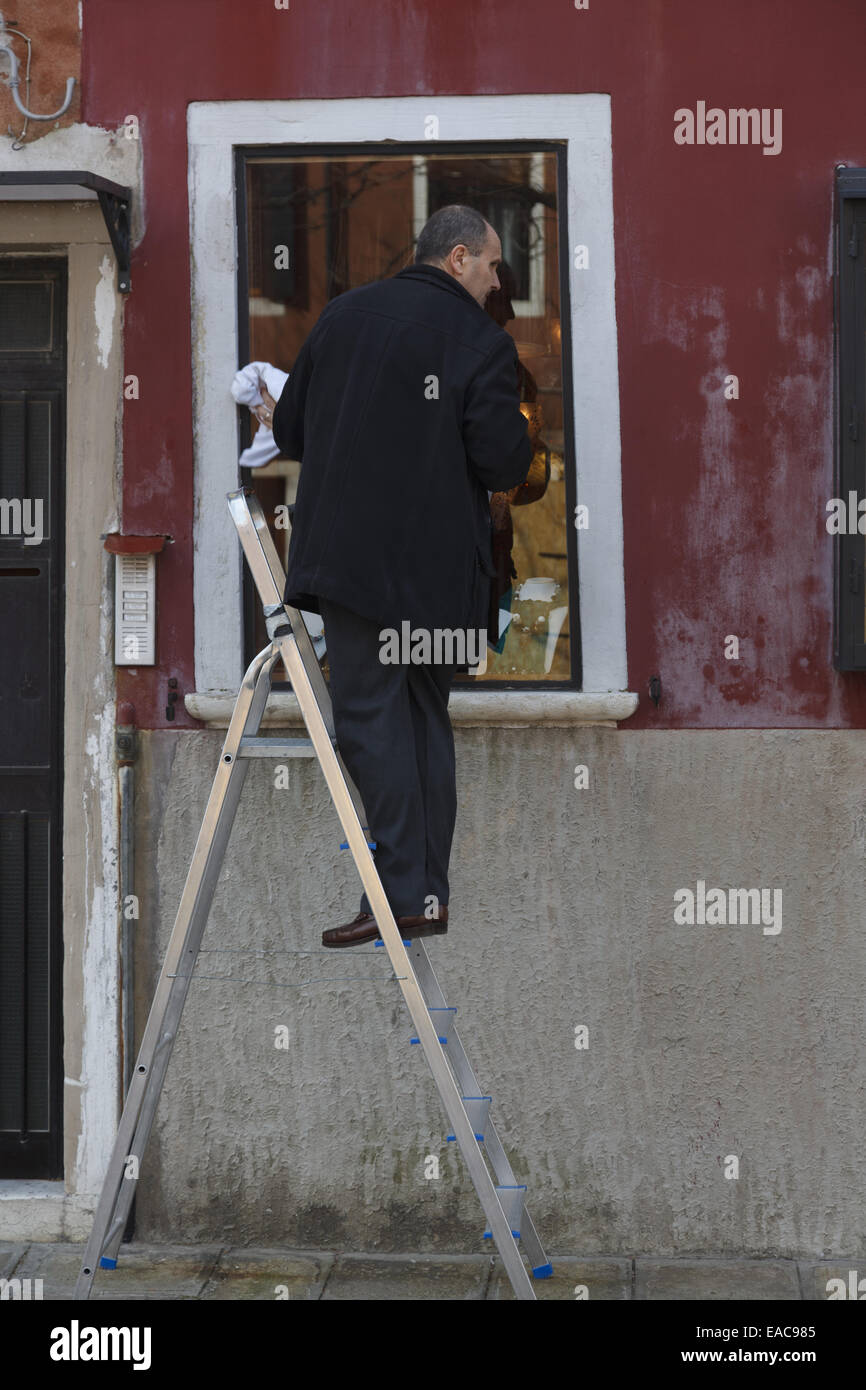 man standing on ladder Stock Photo - Alamy