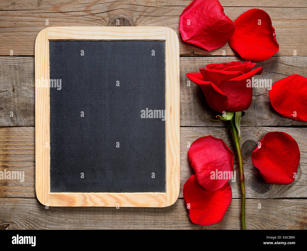 Blackboard and red rose on wooden background Stock Photo - Alamy