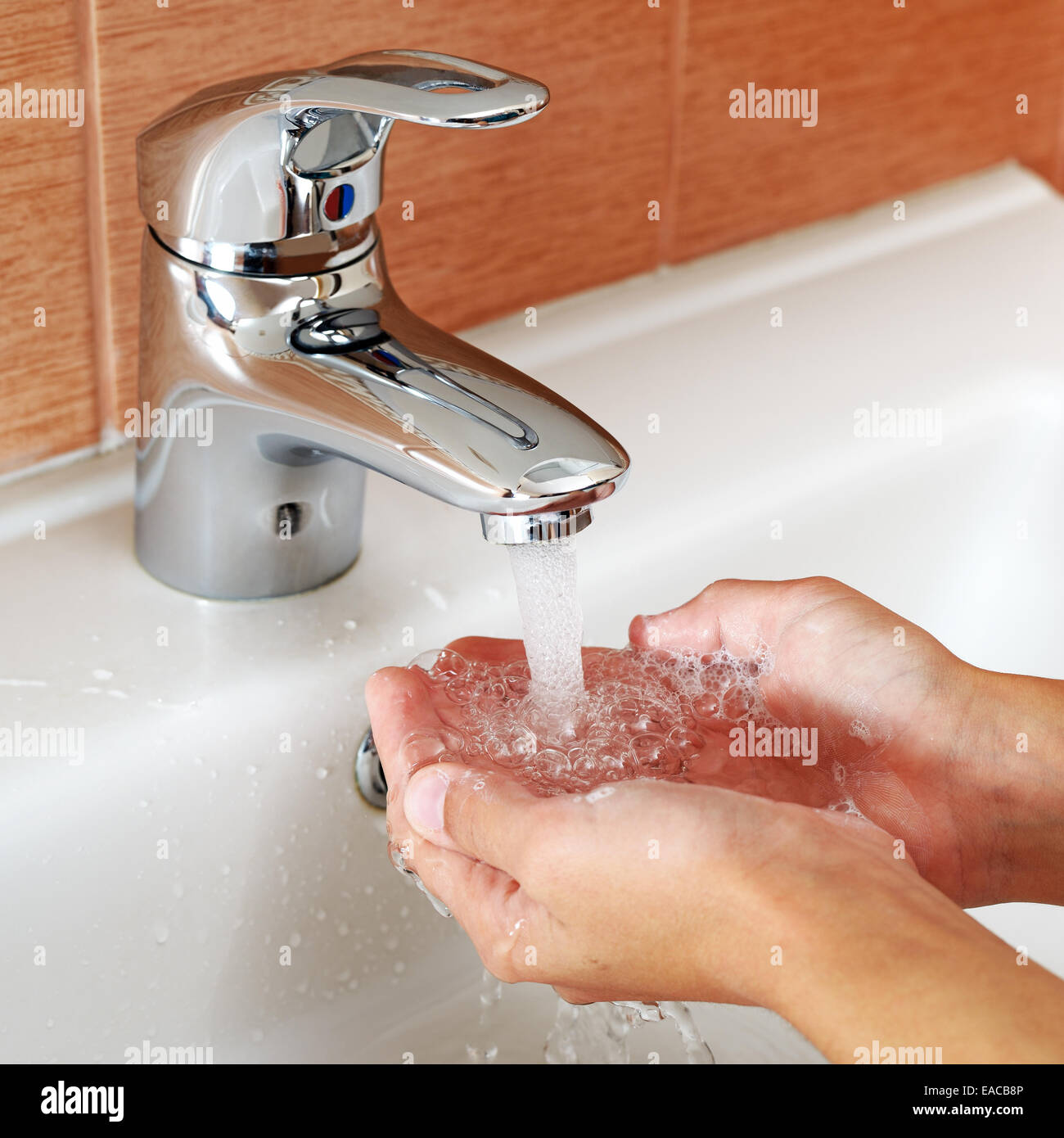 Washing hands under tap water Stock Photo - Alamy