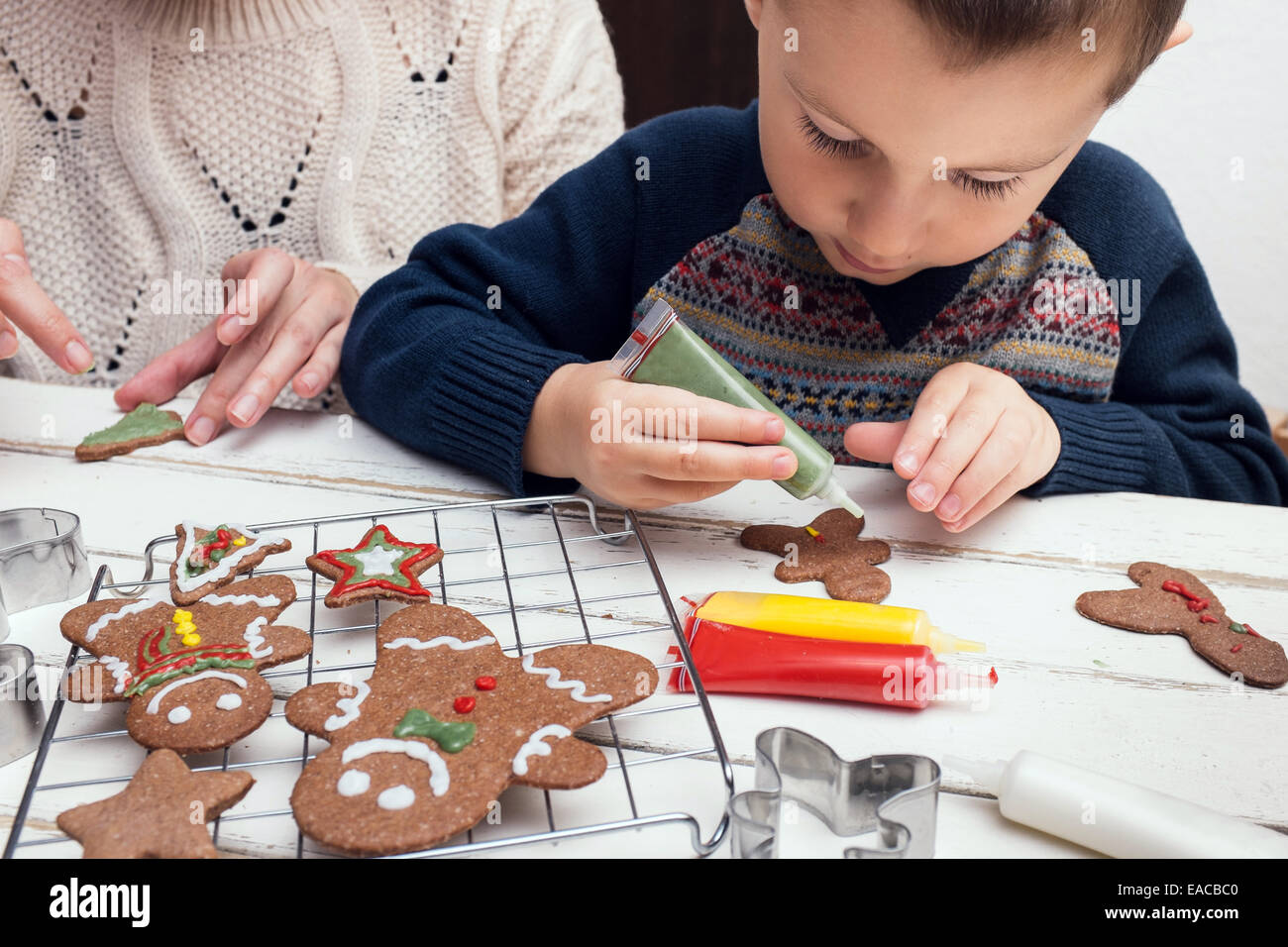 Little boy painting gingerbread man Stock Photo - Alamy