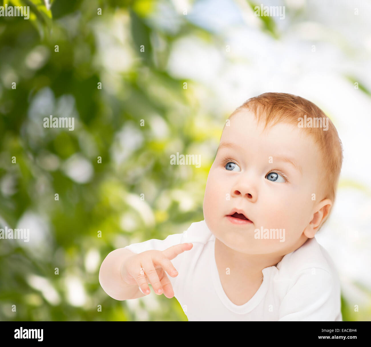 curious baby lying on floor and looking side Stock Photo - Alamy