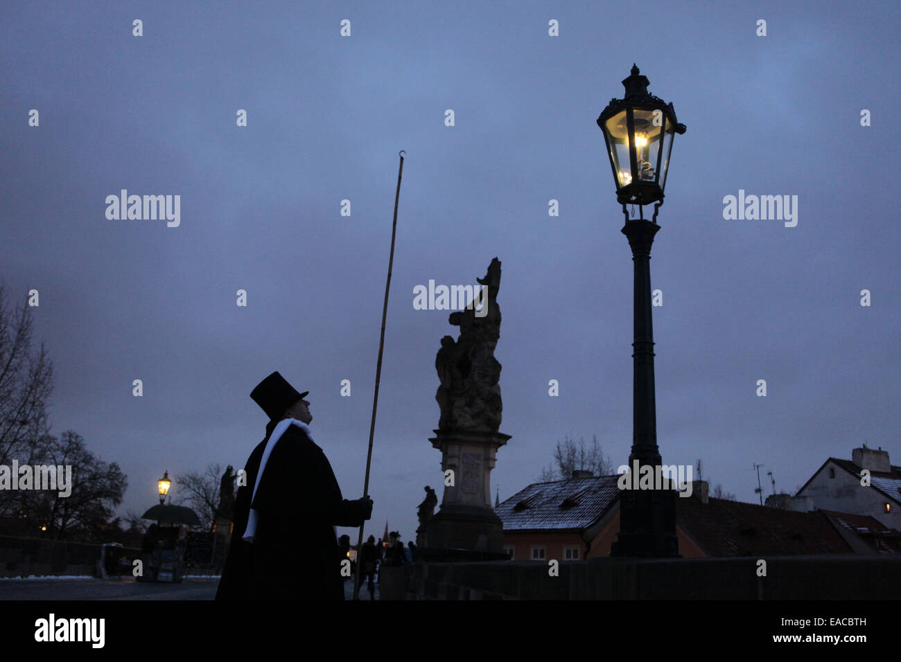 Lamplighter lights a street gas light manually during the Advent time ...