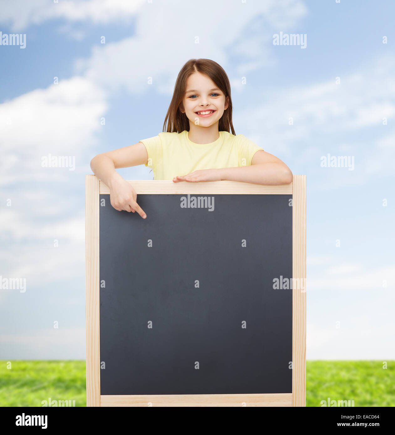 happy little girl pointing finger to blackboard Stock Photo - Alamy