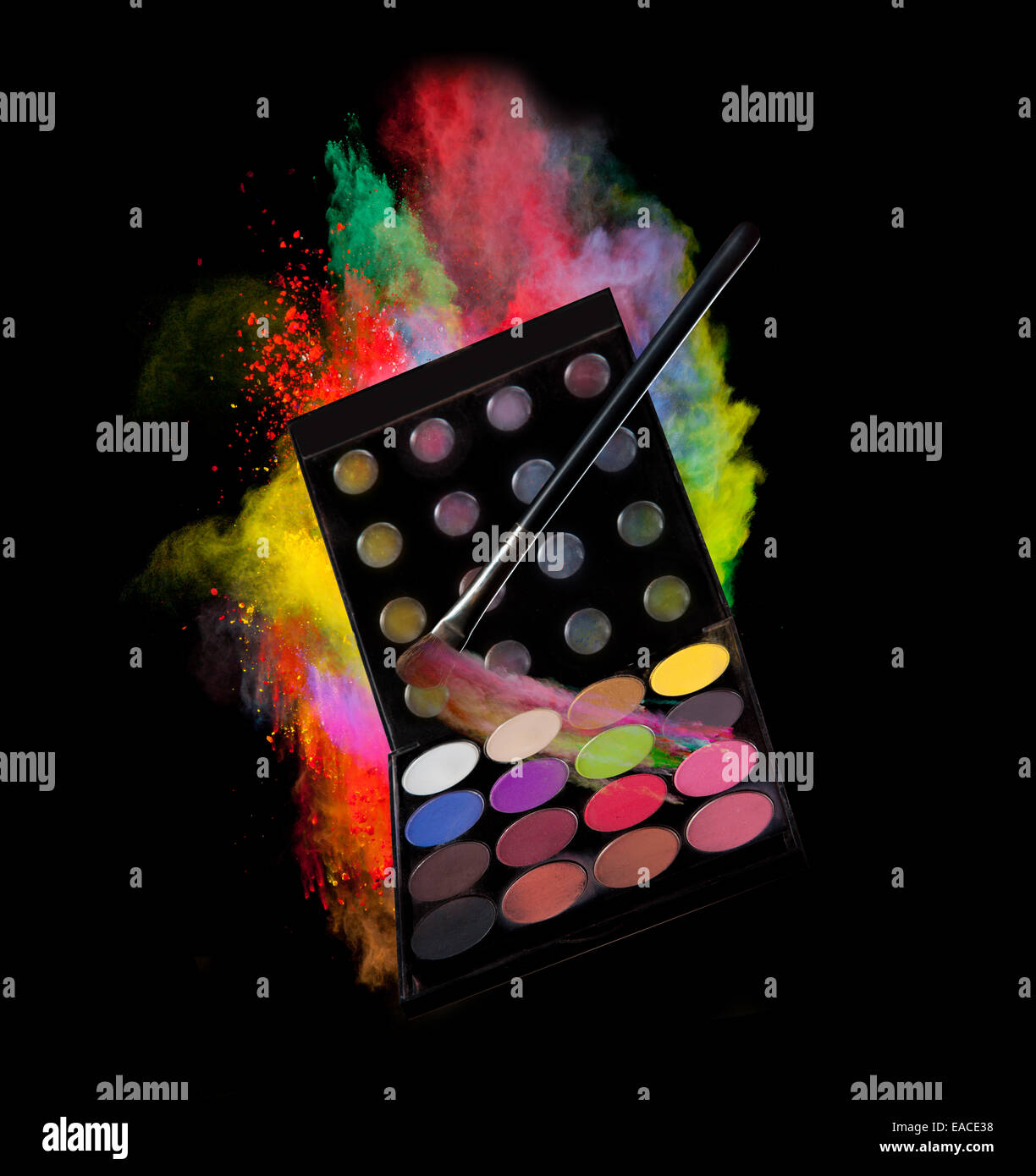 Freeze motion of colored dust explosion make-up palette and brushes ...