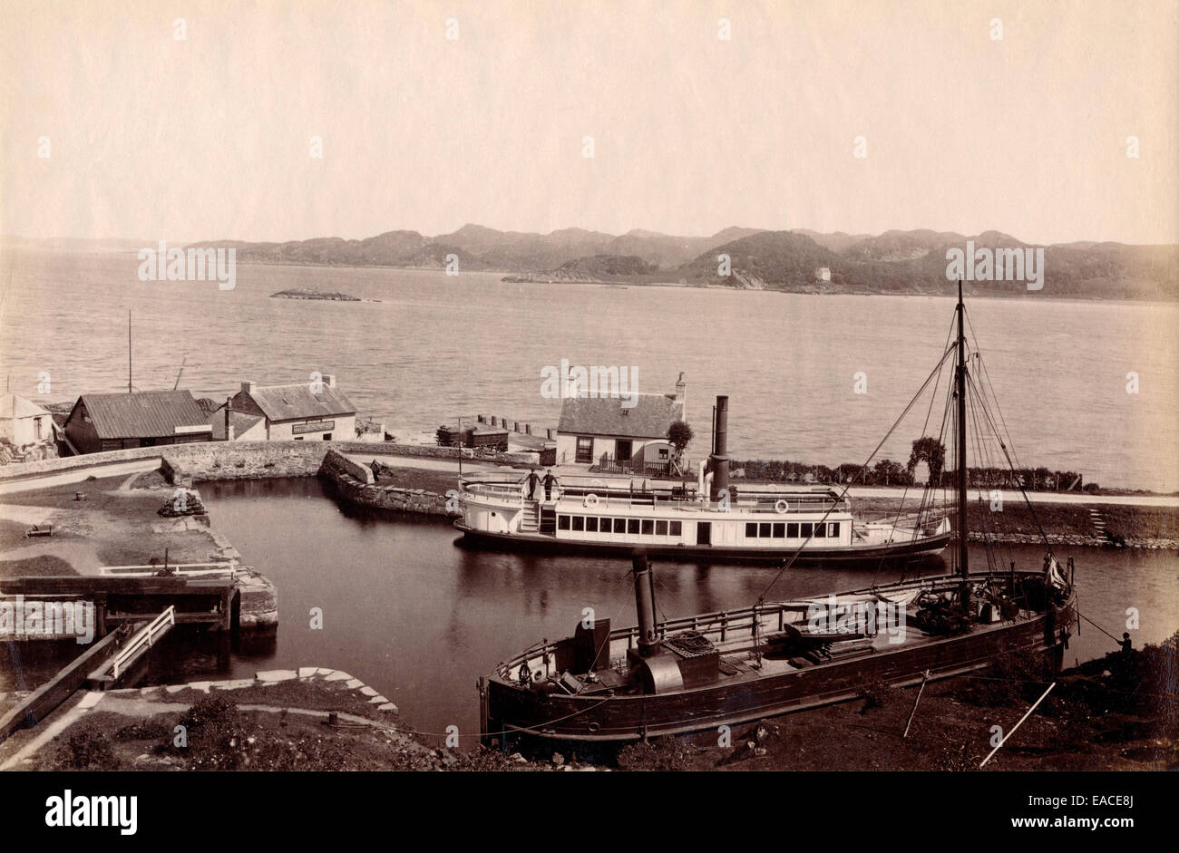 Crinan Canal, with boats and steam barge in harbour at the sea lock at ...