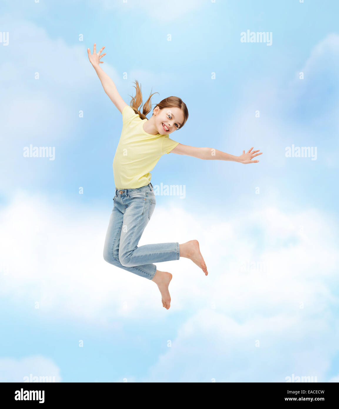 smiling little girl jumping Stock Photo - Alamy