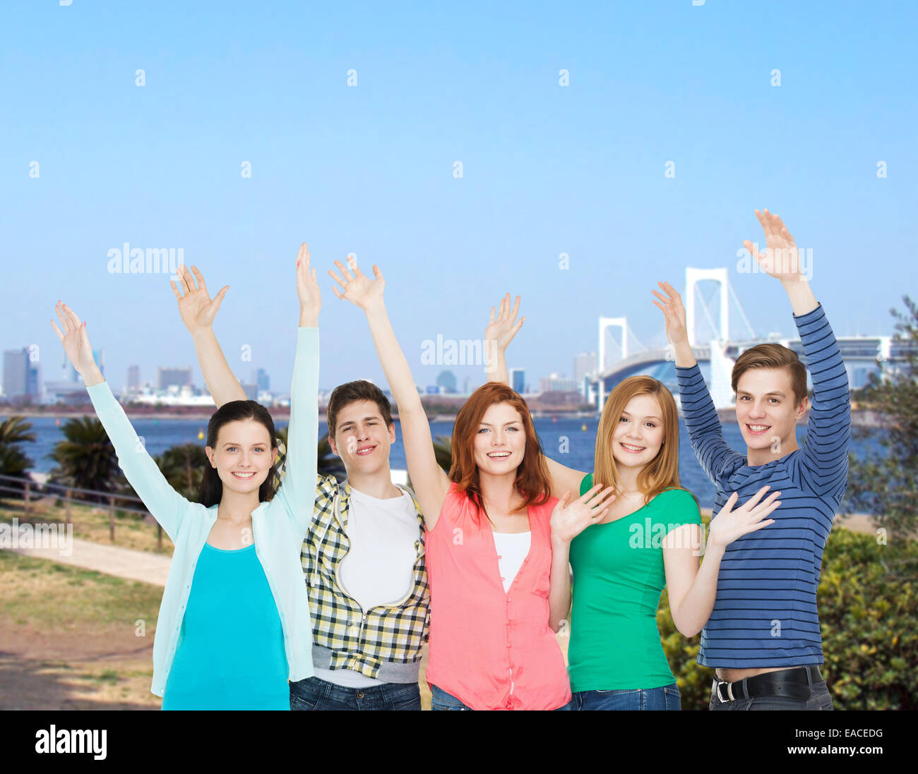 group of smiling students waving hands Stock Photo - Alamy