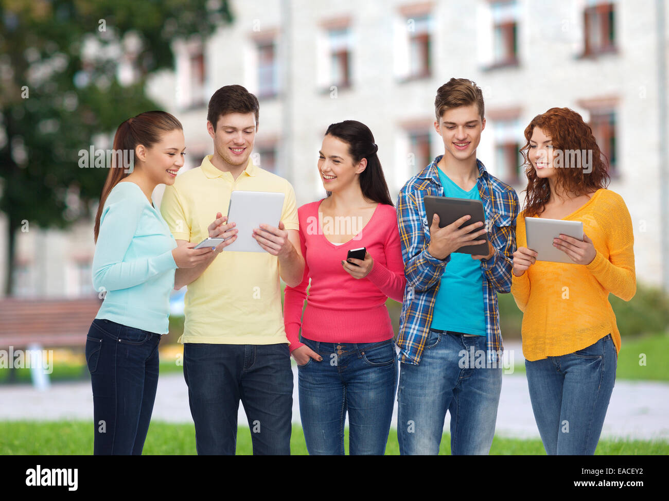 group of teenagers with smartphones and tablet pc Stock Photo - Alamy