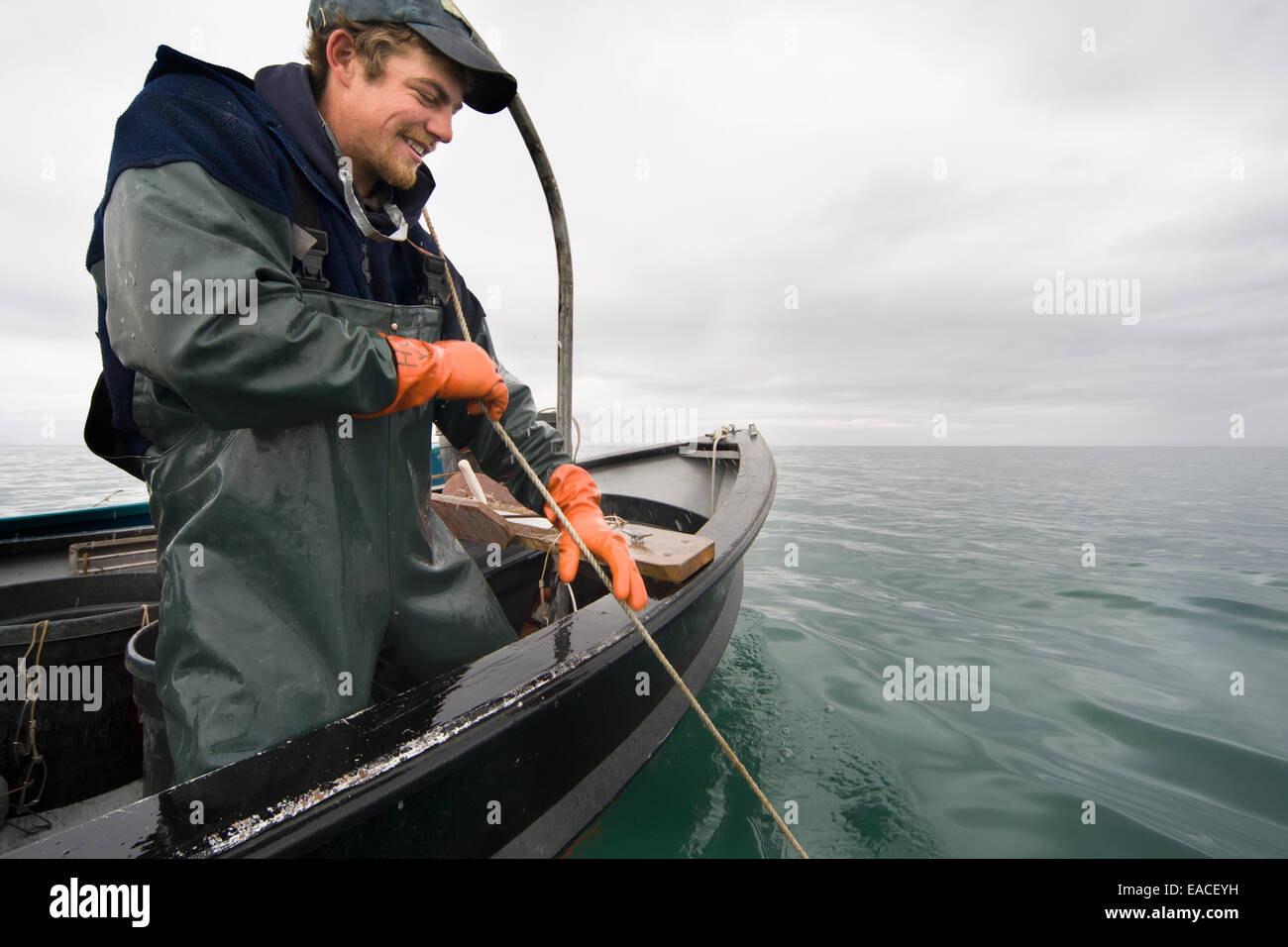 Commercial halibut fishing by hand using longline gear out of an open ...