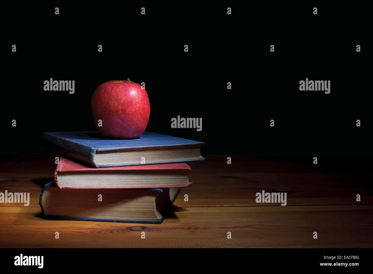 Stack of books and apple with background copyspace Stock Photo - Alamy