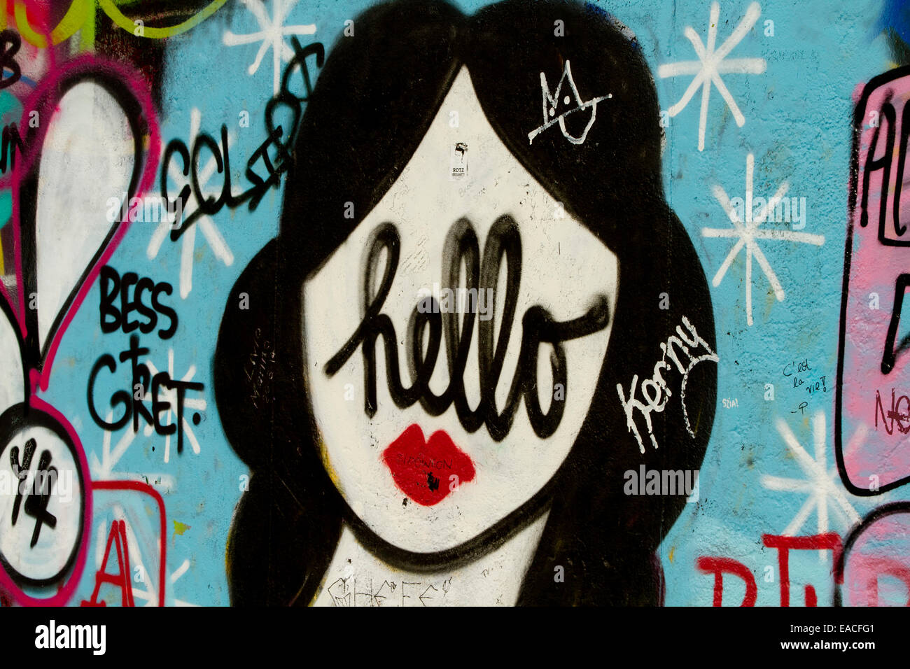 Graffiti street art Berlin wall girl face hello Stock Photo - Alamy