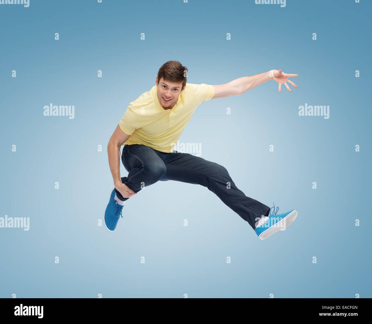 smiling young man jumping in air Stock Photo - Alamy