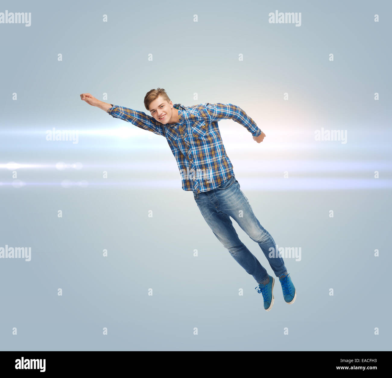 smiling young man jumping in air Stock Photo - Alamy