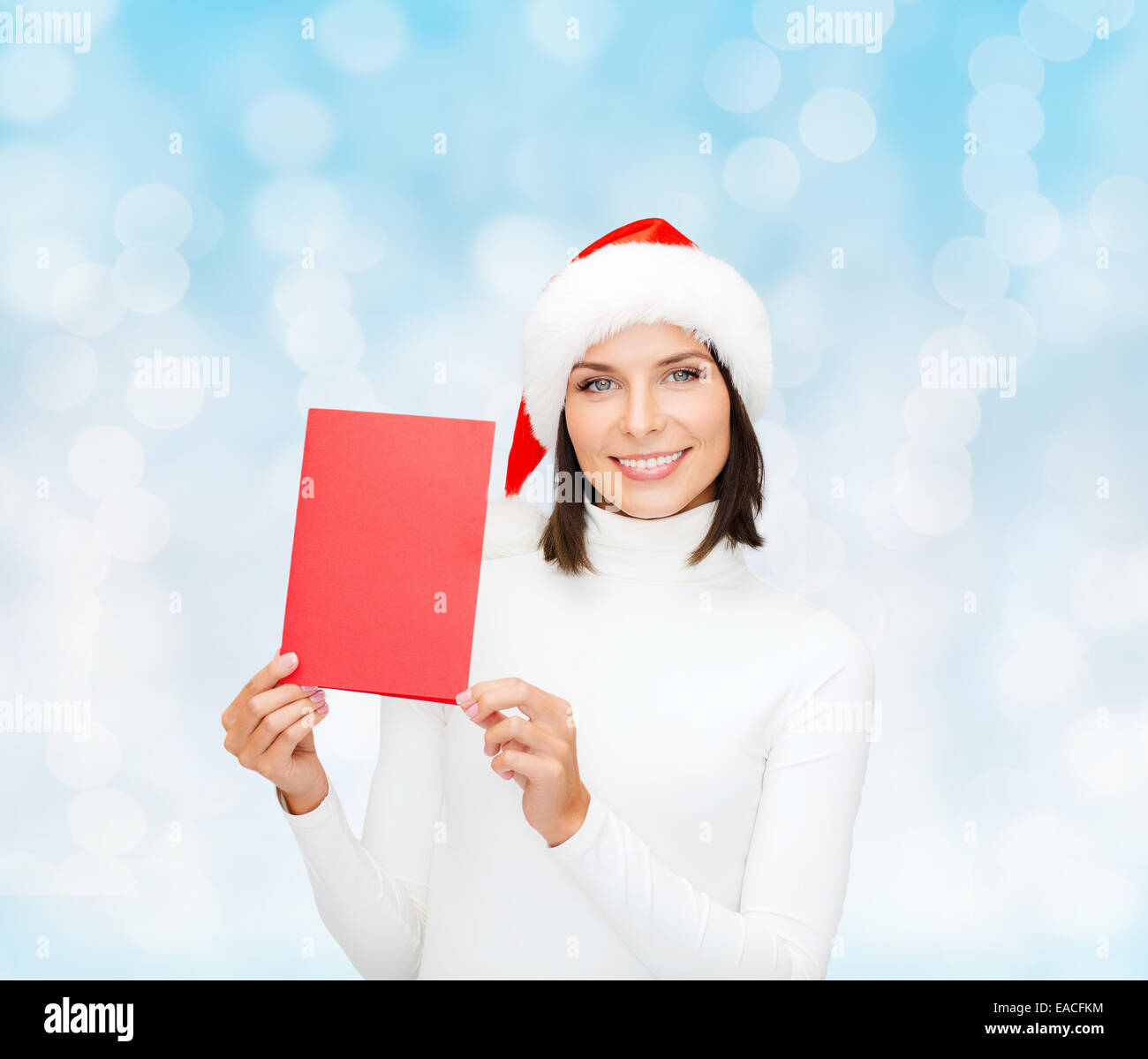 smiling woman in santa hat with greeting card Stock Photo - Alamy
