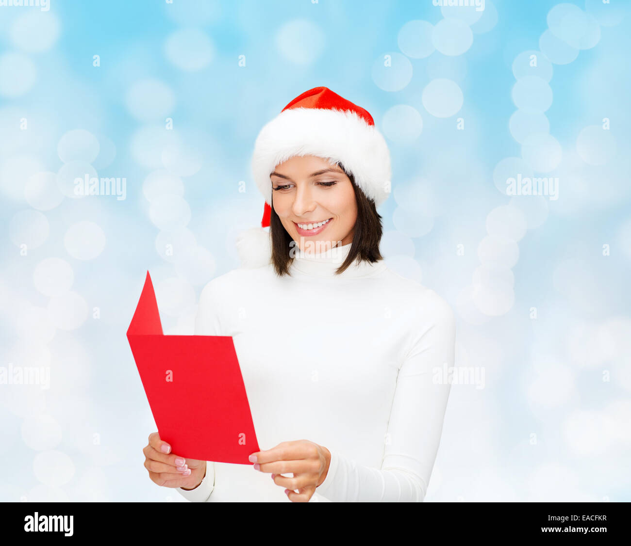 smiling woman in santa hat with greeting card Stock Photo - Alamy