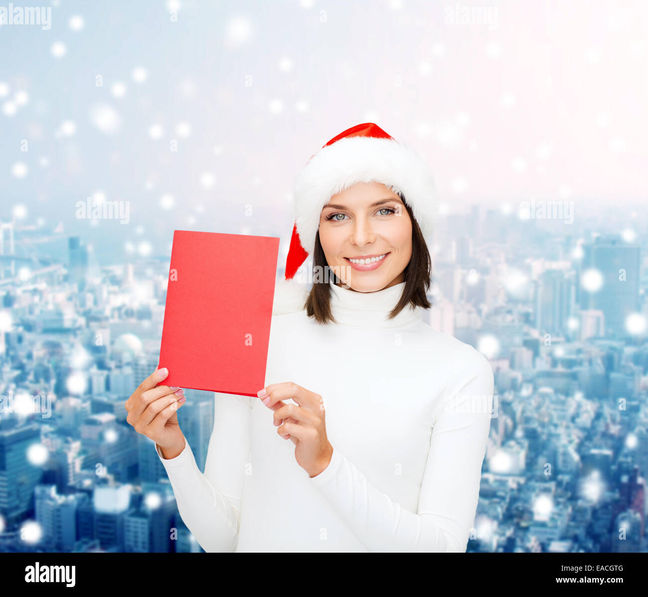 smiling woman in santa hat with greeting card Stock Photo - Alamy