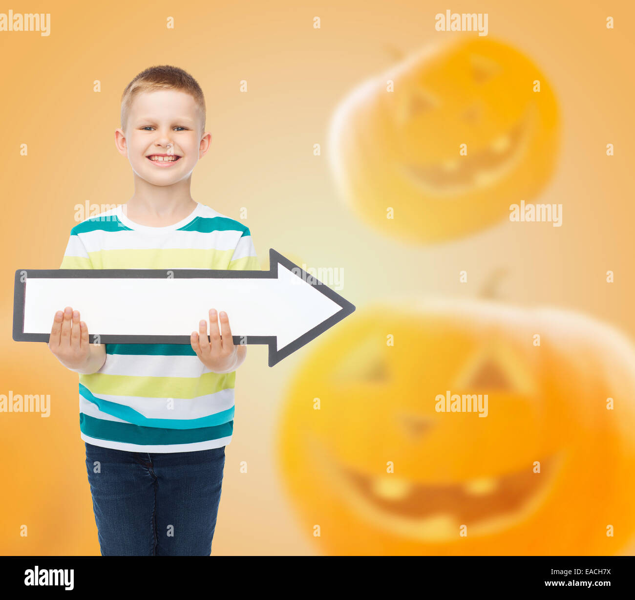 smiling little boy holding big white arrow Stock Photo - Alamy