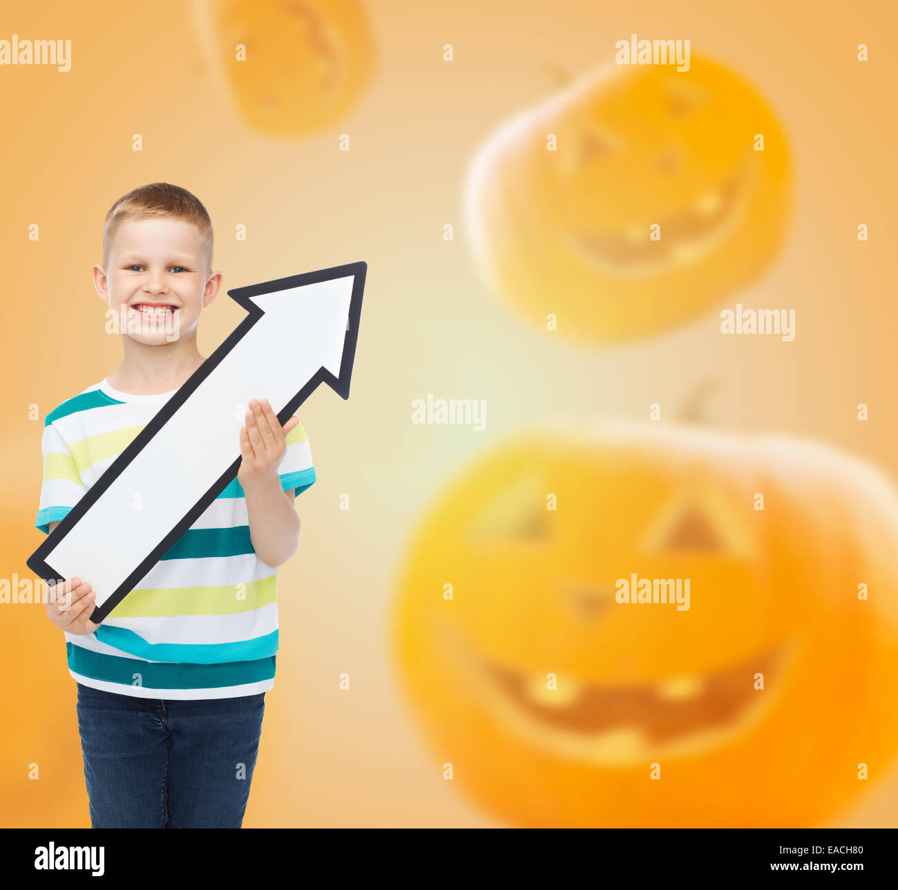 smiling little boy holding big white arrow Stock Photo - Alamy