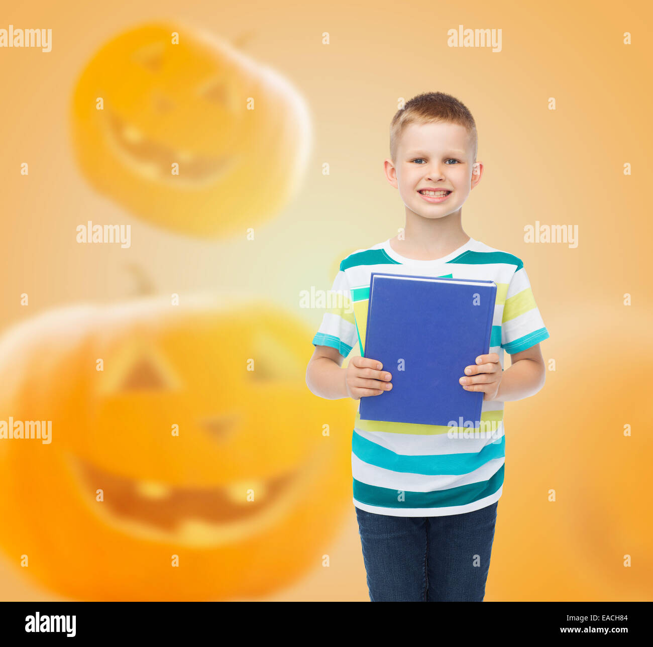 smiling little student boy with blue book Stock Photo - Alamy