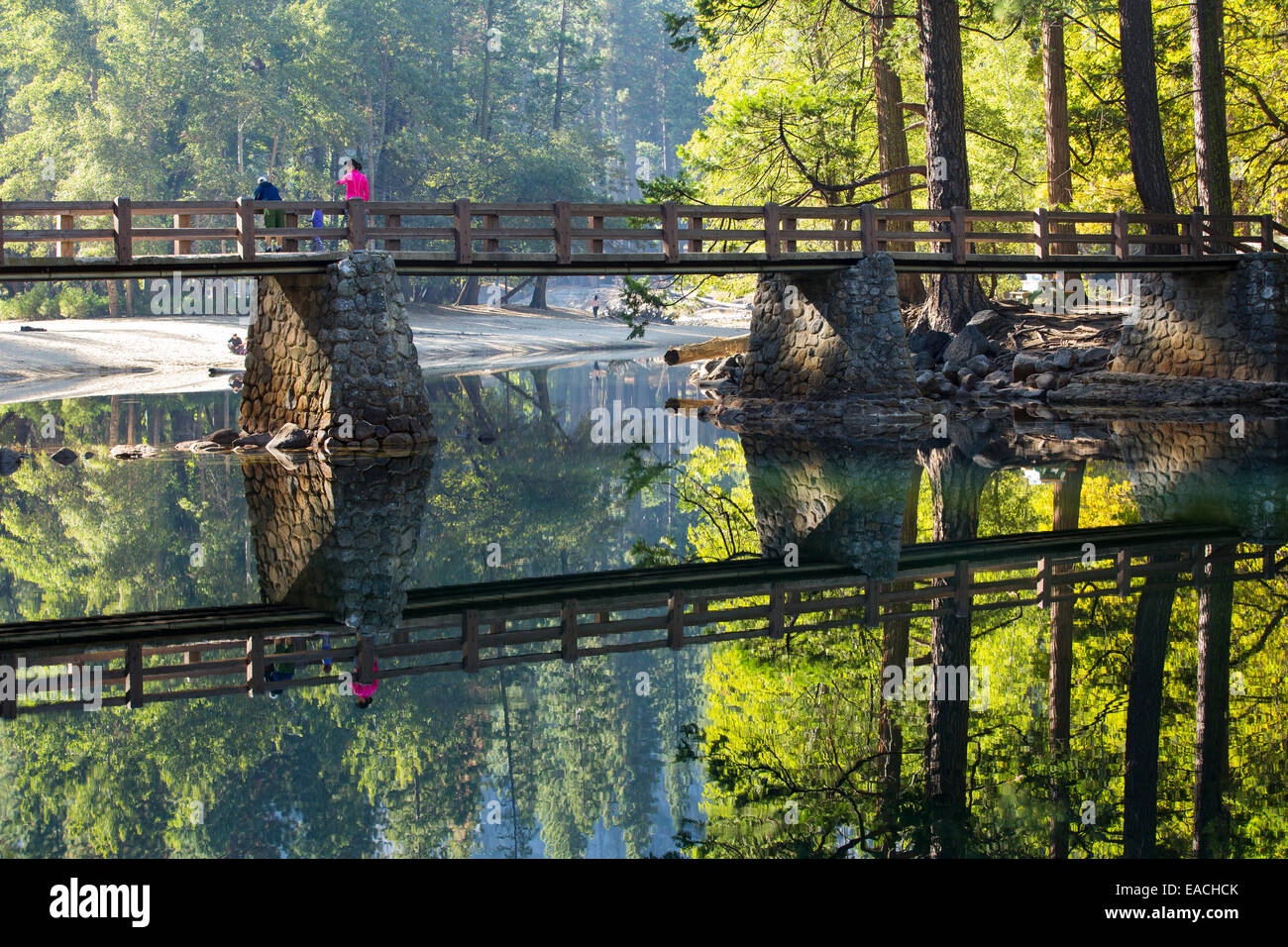 Reflections and a bridge crossing the Merced River, Yosemite Valley ...