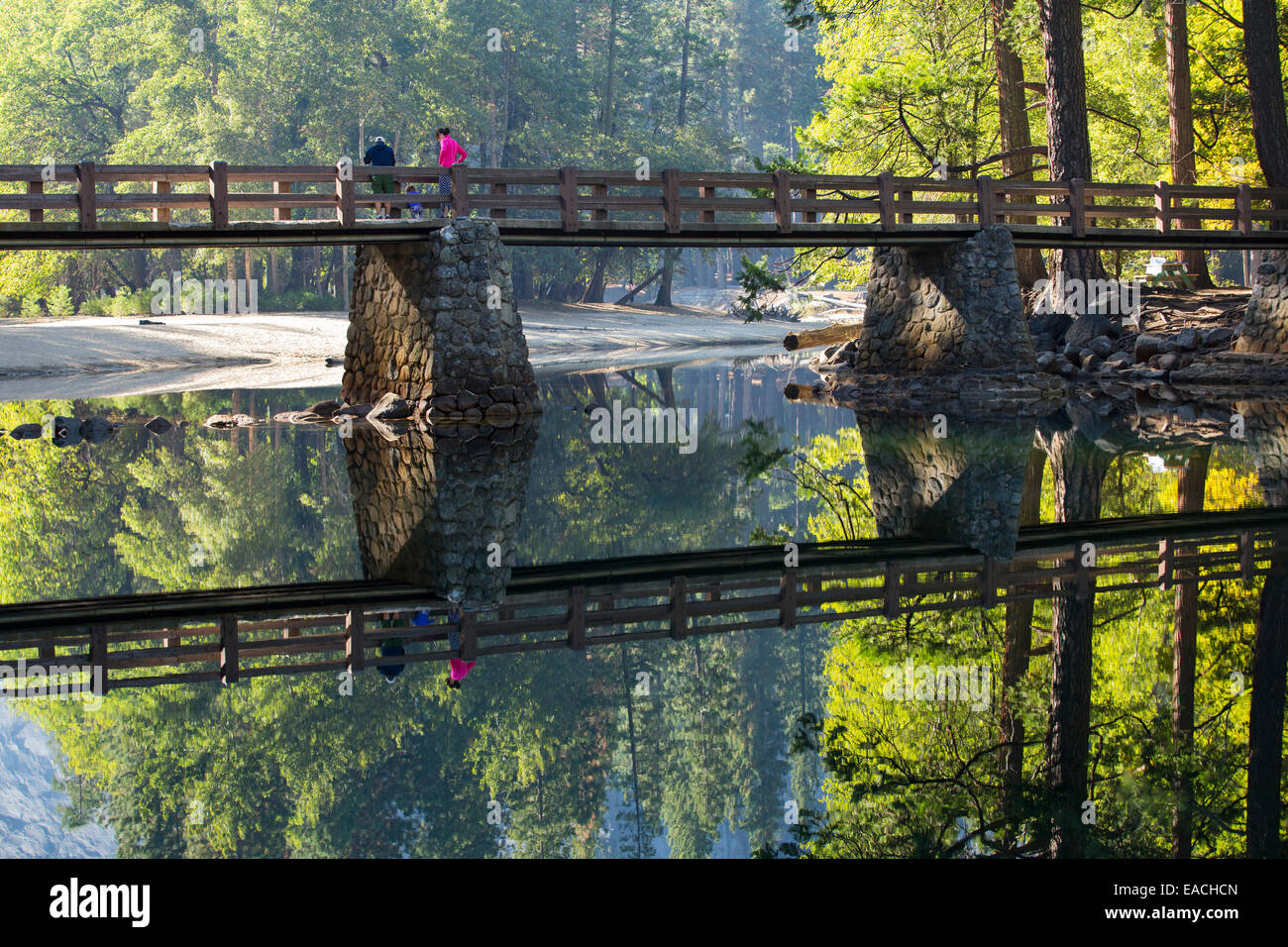 Reflections and a bridge crossing the Merced River, Yosemite Valley ...
