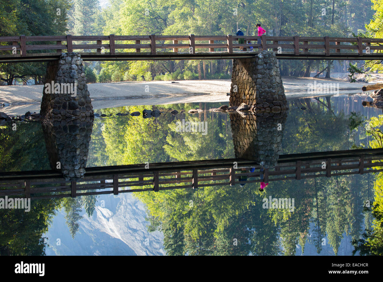 Reflections and a bridge crossing the Merced River, Yosemite Valley ...