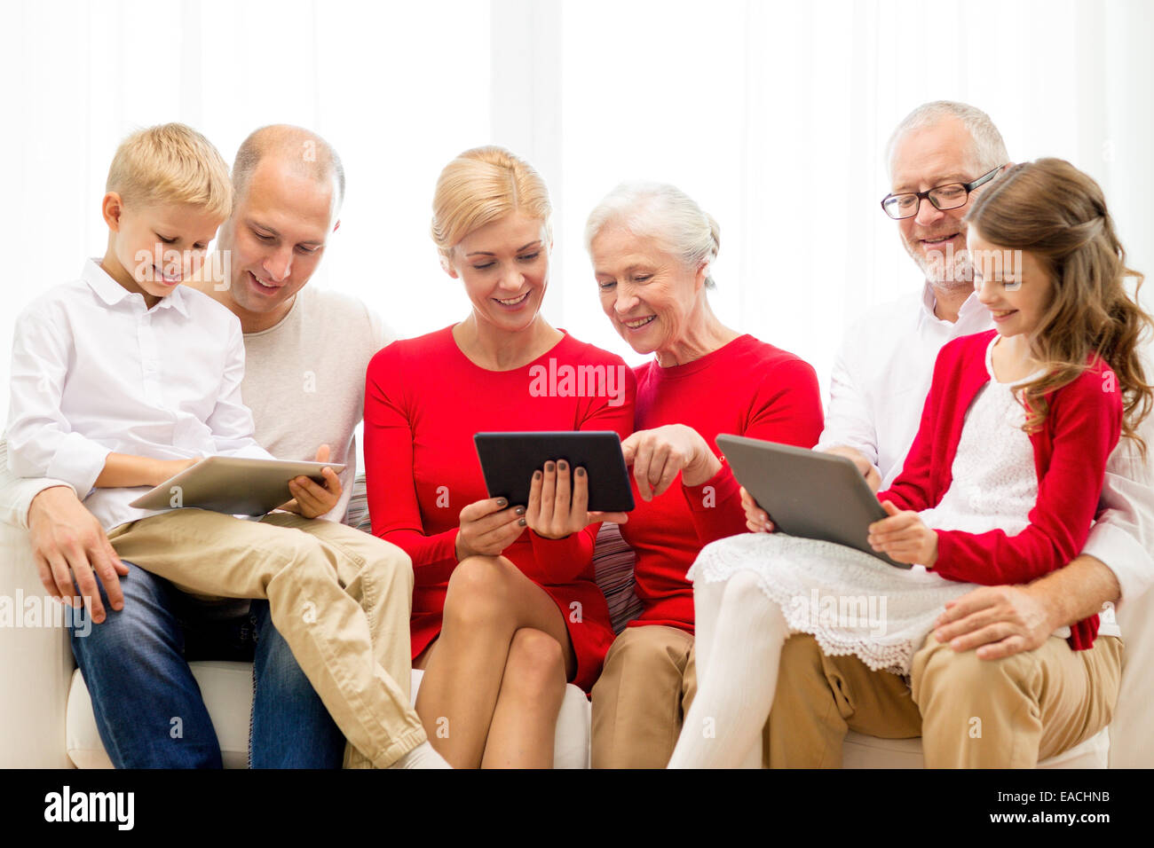 smiling family with tablet pc computers at home Stock Photo - Alamy