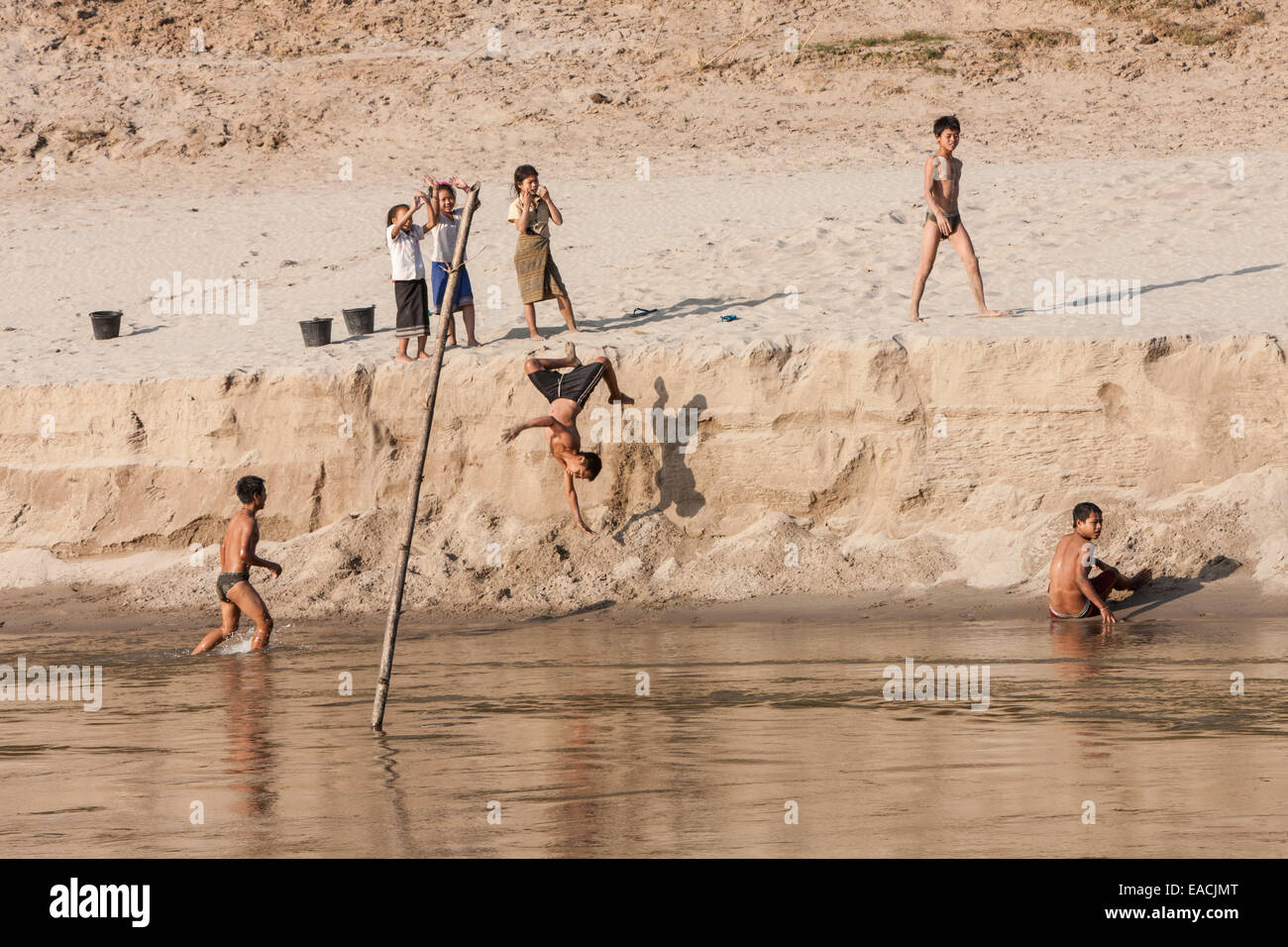 Children playing on riverbank. on a two day cruise on a slow ferry boat ...