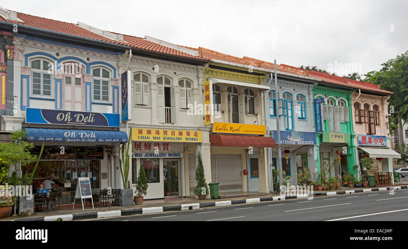 Row of colourful shops, including open fronted cafe / deli , in double ...