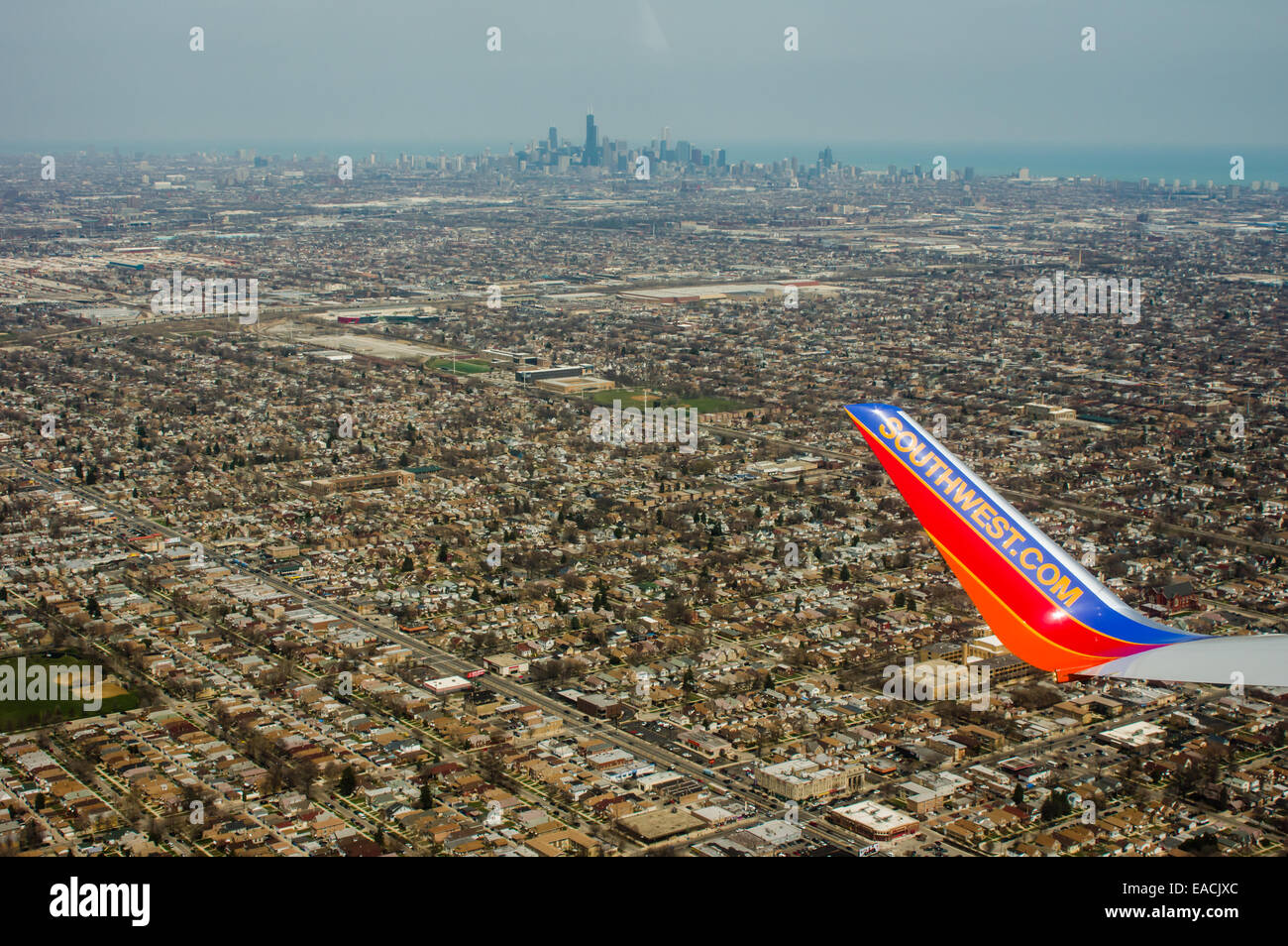 Aerial view of Chicago, Illinois showing aircraft wing and suburban ...
